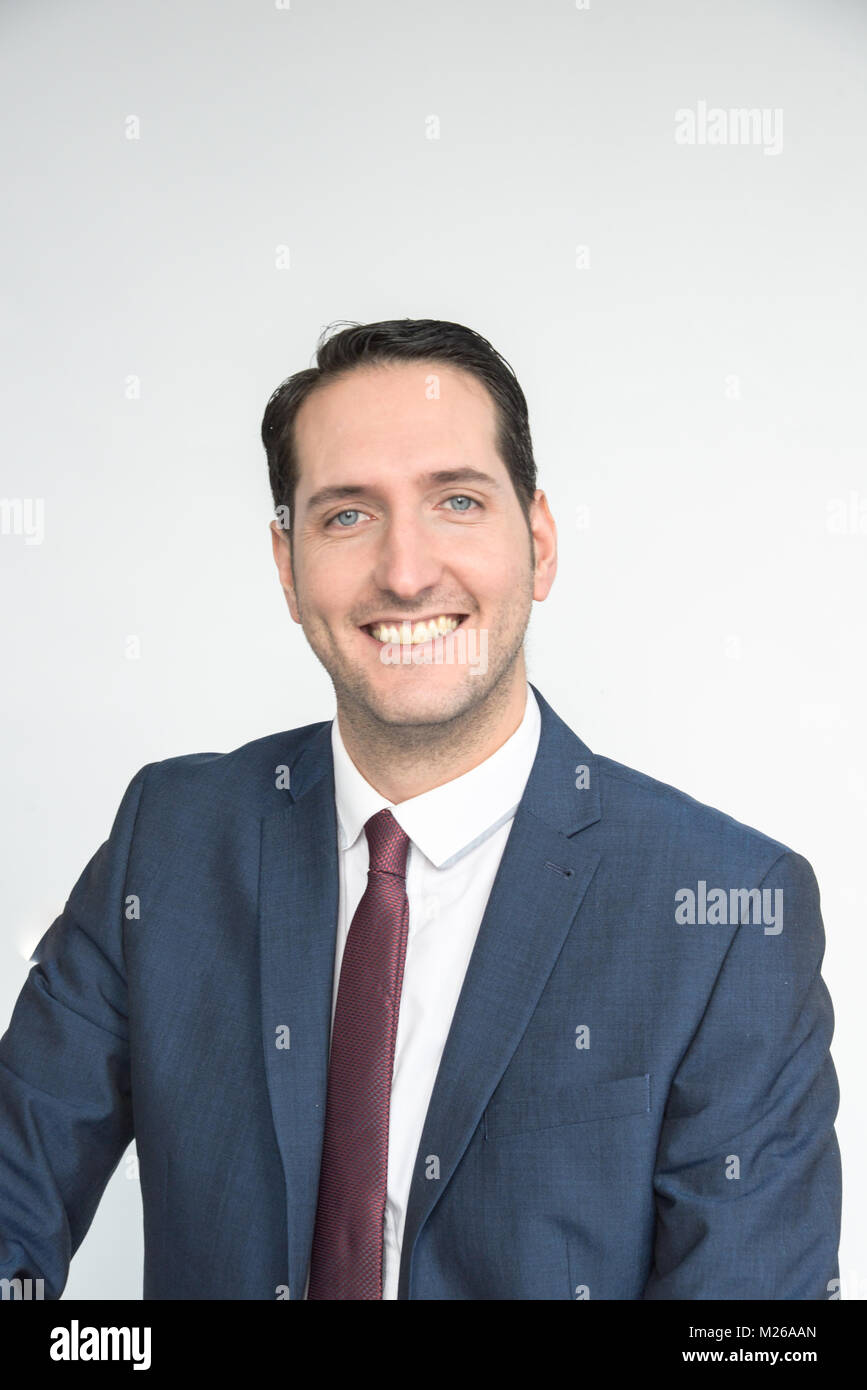 Portrait of a smartly dressed good looking man smiling and happy ...