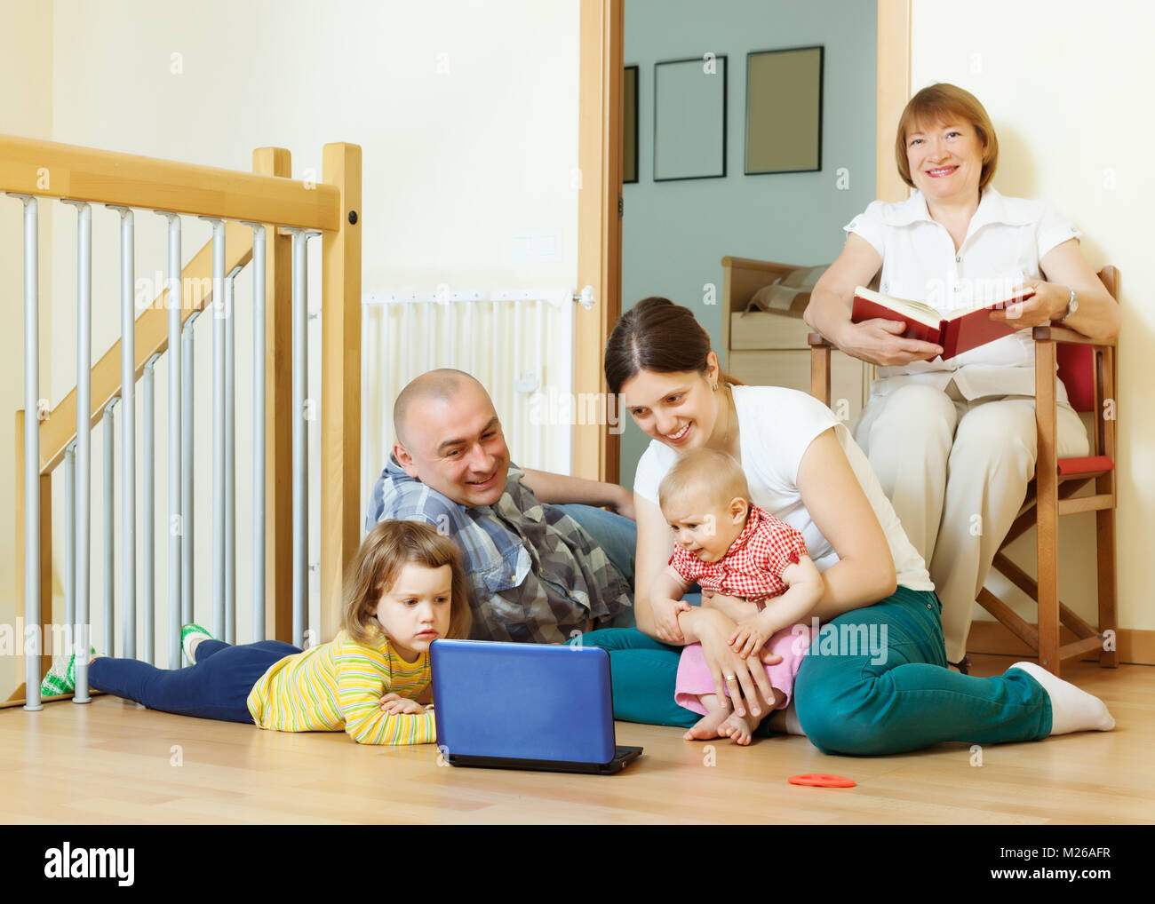 three generations family with two children enjoying at home together ...