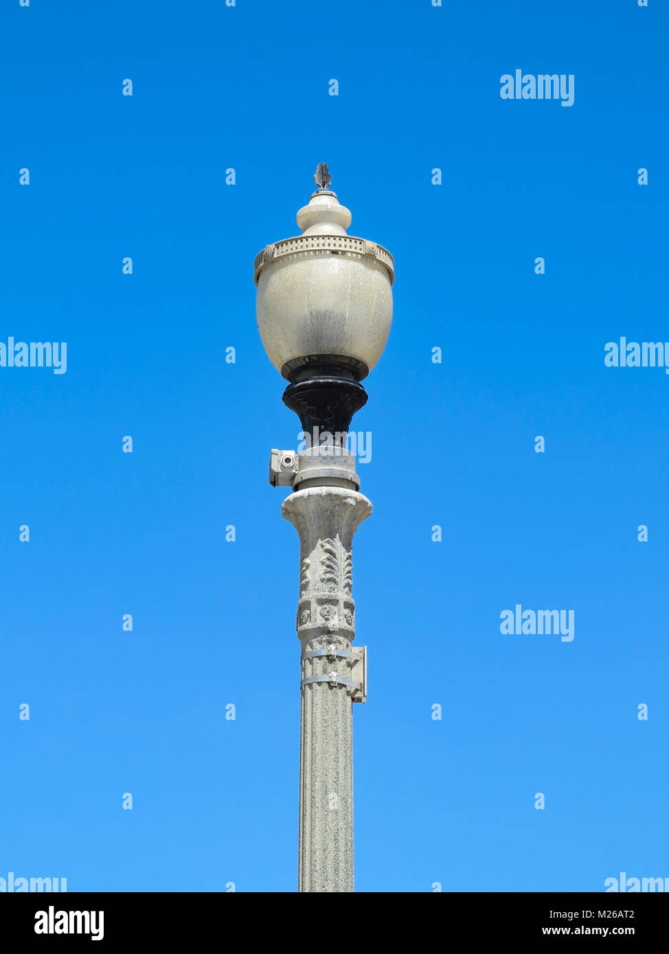 A tall lamp post with blue sky behind Stock Photo - Alamy