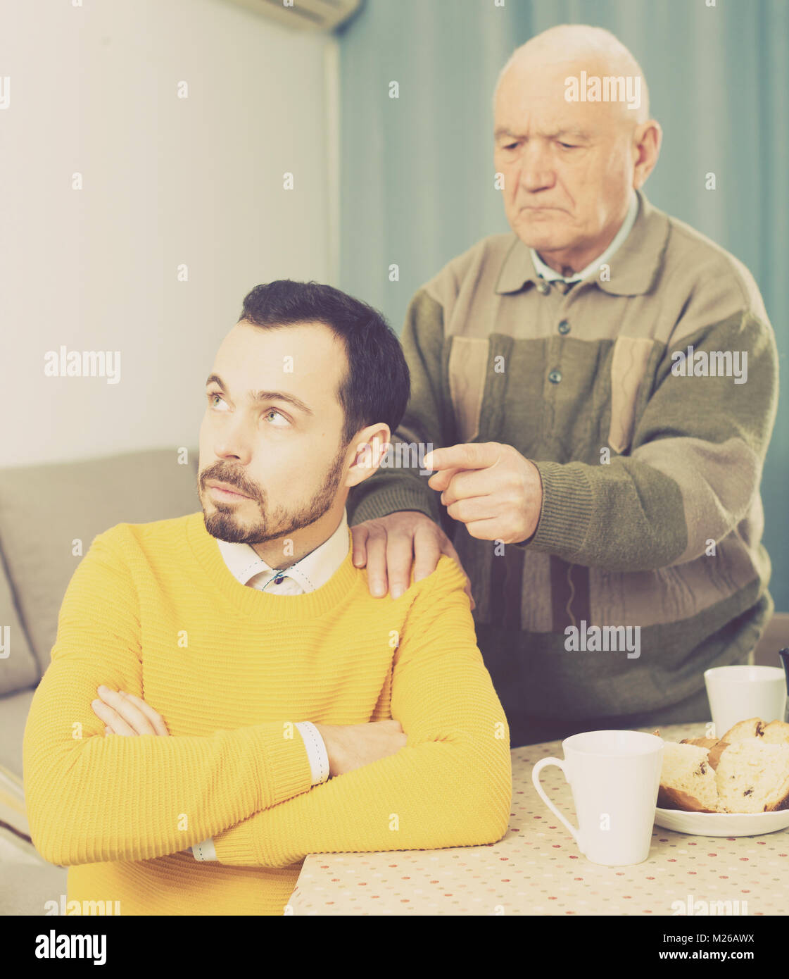 Aged father arguing with her adult son at home Stock Photo - Alamy