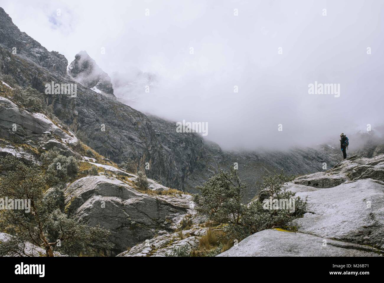 Person looks into distance in the mist Stock Photo - Alamy