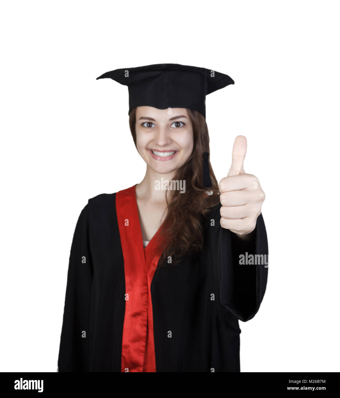 Smiling young woman in graduation gown showing thumbs up Stock Photo ...