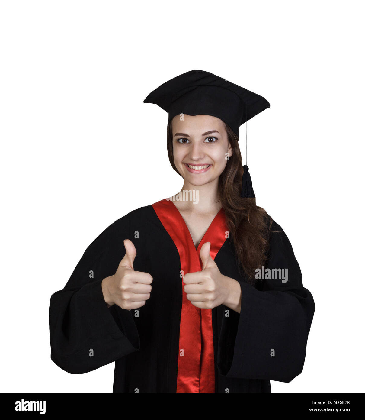Smiling young woman in graduation gown showing thumbs up Stock Photo ...