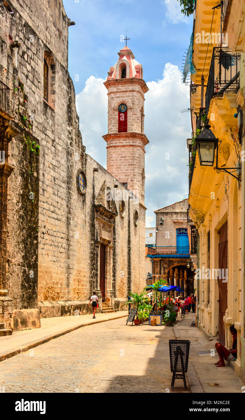 Narrow street of an ancient city in the summer noon with a view of the ...
