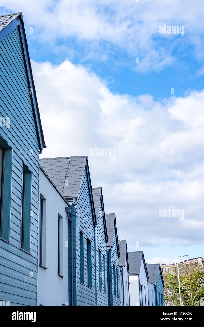 Line of timber faced terraced houses with blue sky background Stock ...