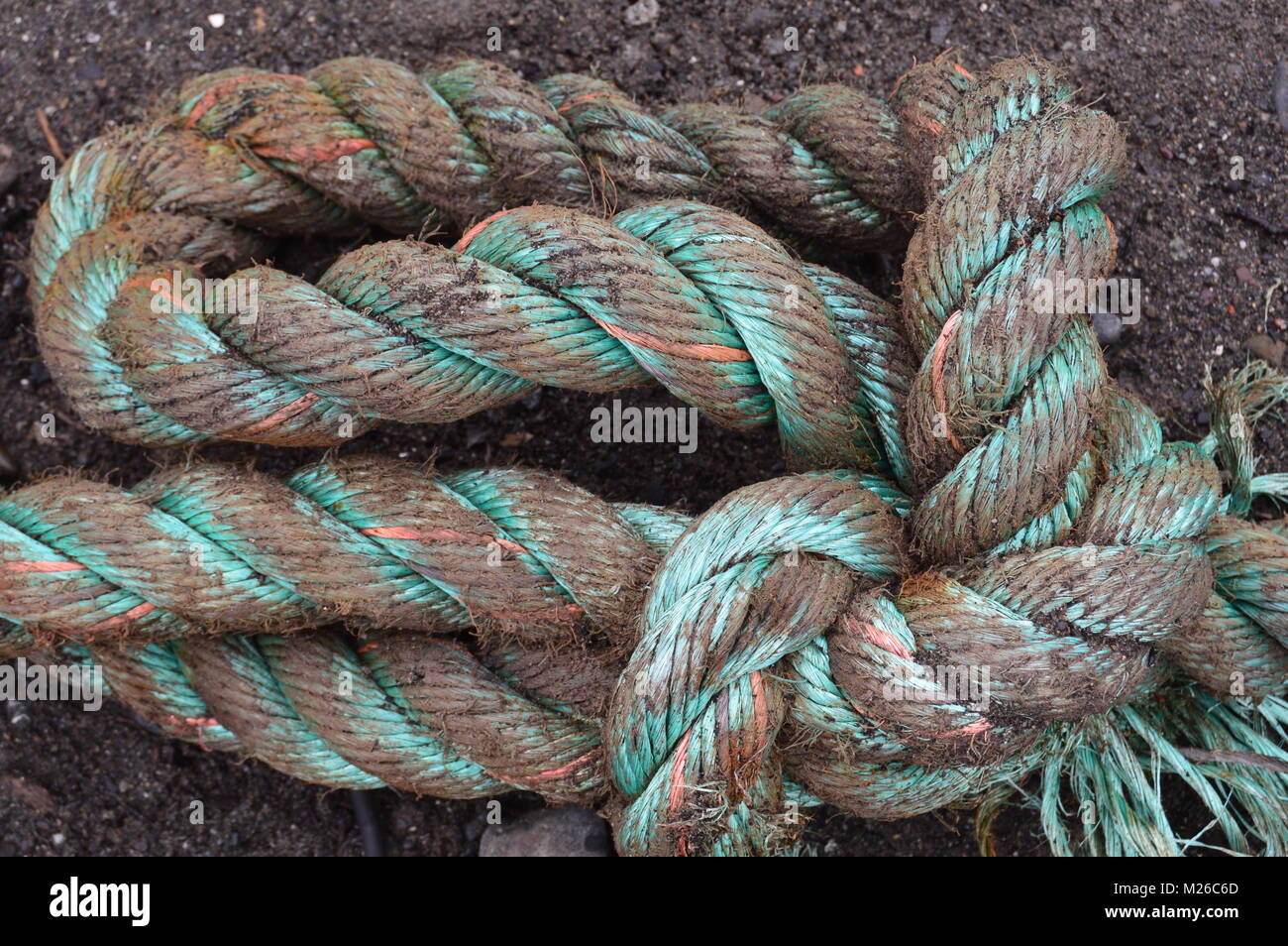 Dirty old rope in harbour Stock Photo - Alamy