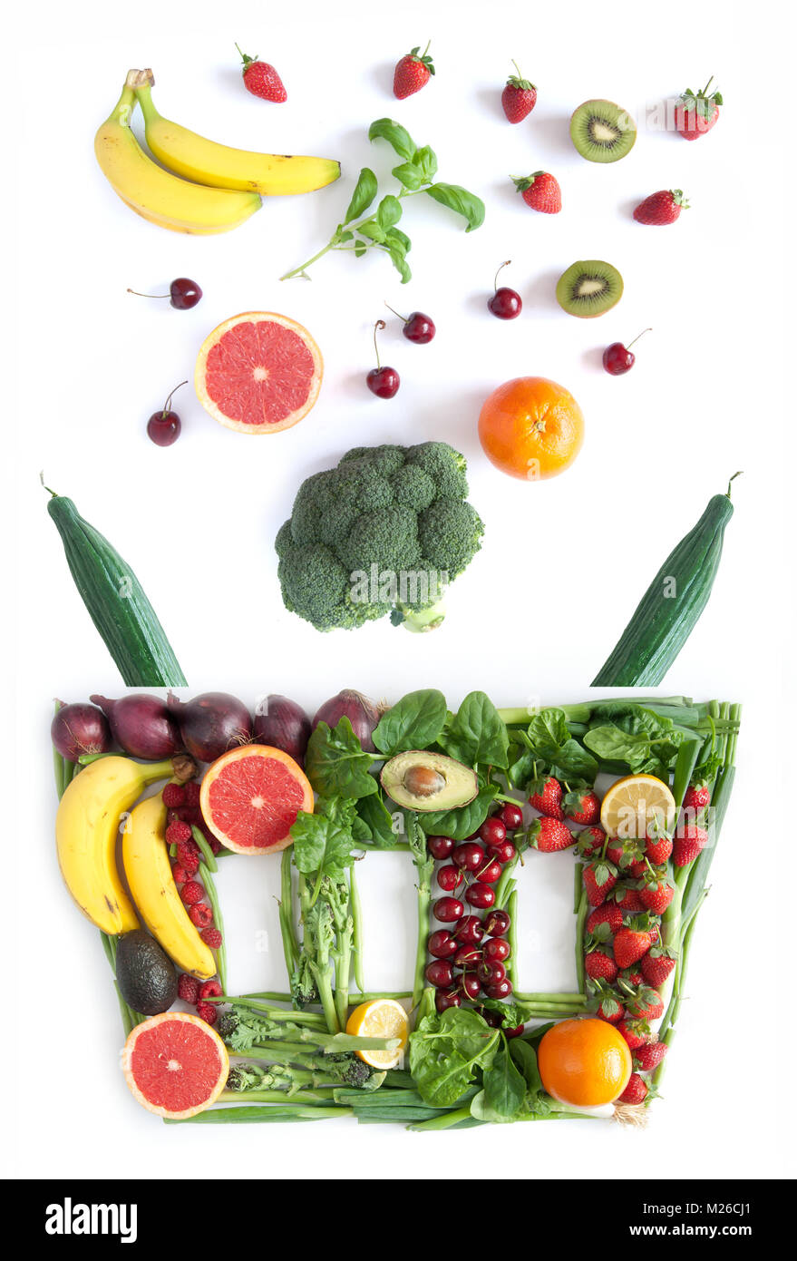Food falling into a grocery basket made of food over a white background ...
