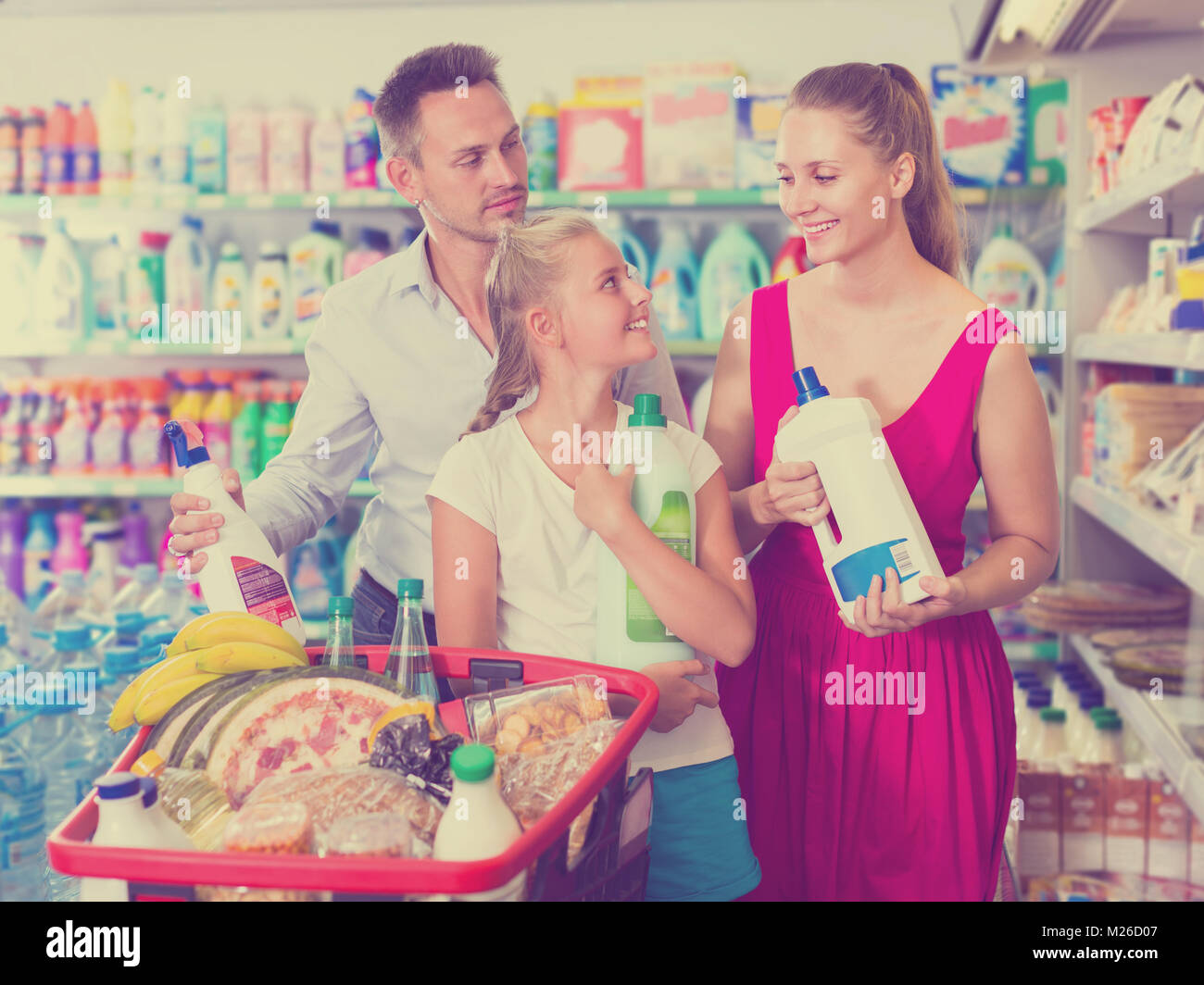 Portrait of charming people showing household goods purchase in the ...