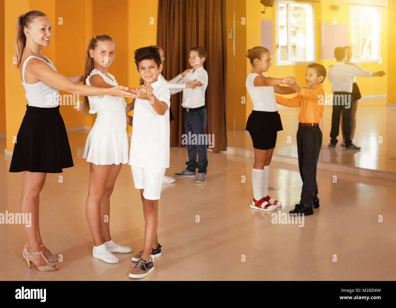 Group of smiling positive children dancing tango in dance studio Stock ...