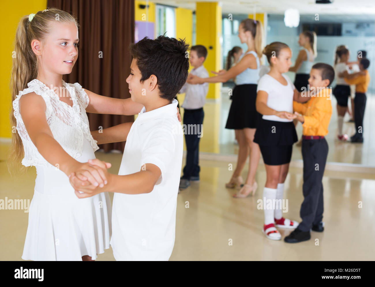 Happy children enjoying of partner dance in class Stock Photo - Alamy