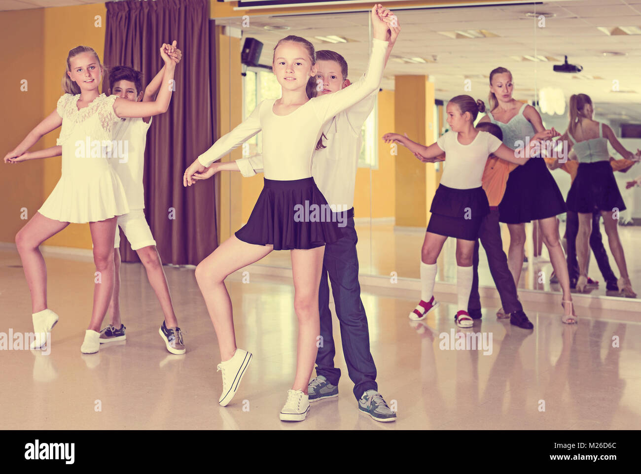 Happy active children enjoying of partner dance in class Stock Photo ...