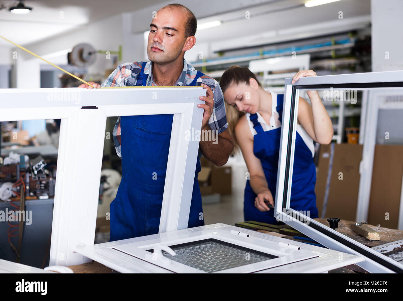 smiling czech foreman explaining plastic windows assembly process to ...