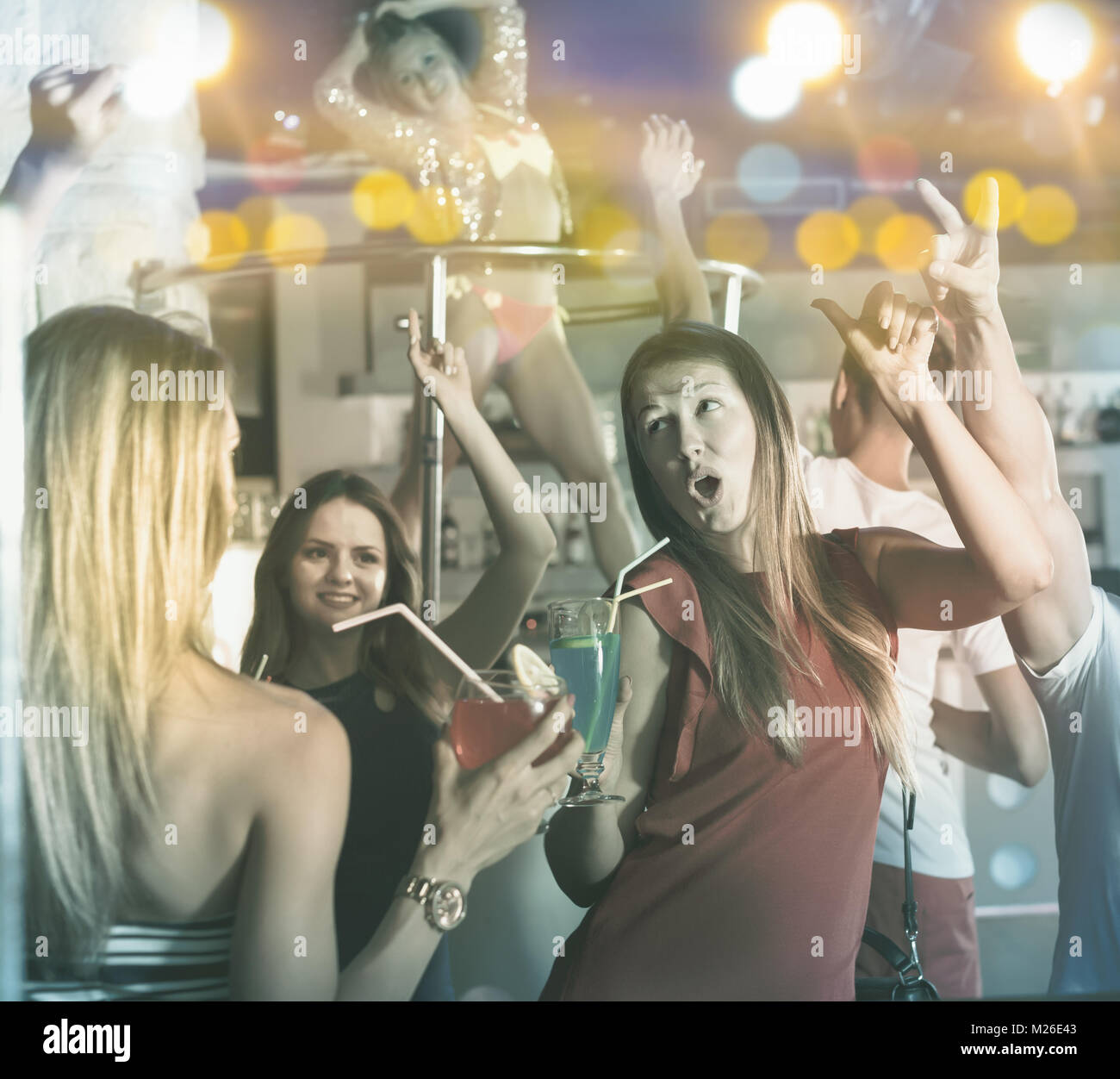 Group of friendly people clubbing in the night club with drink Stock ...