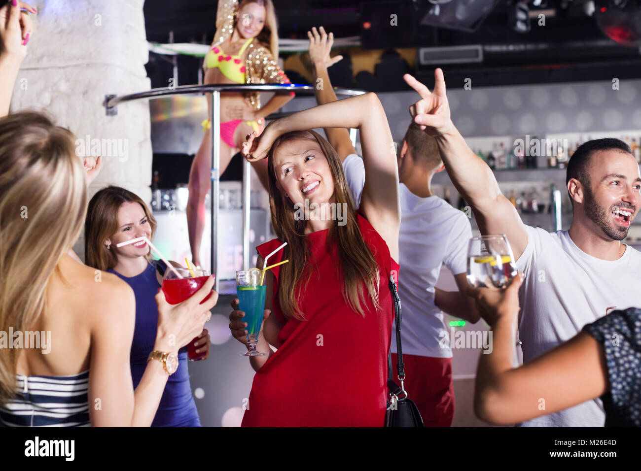 Group of smiling people clubbing in a night club with a drinks Stock ...