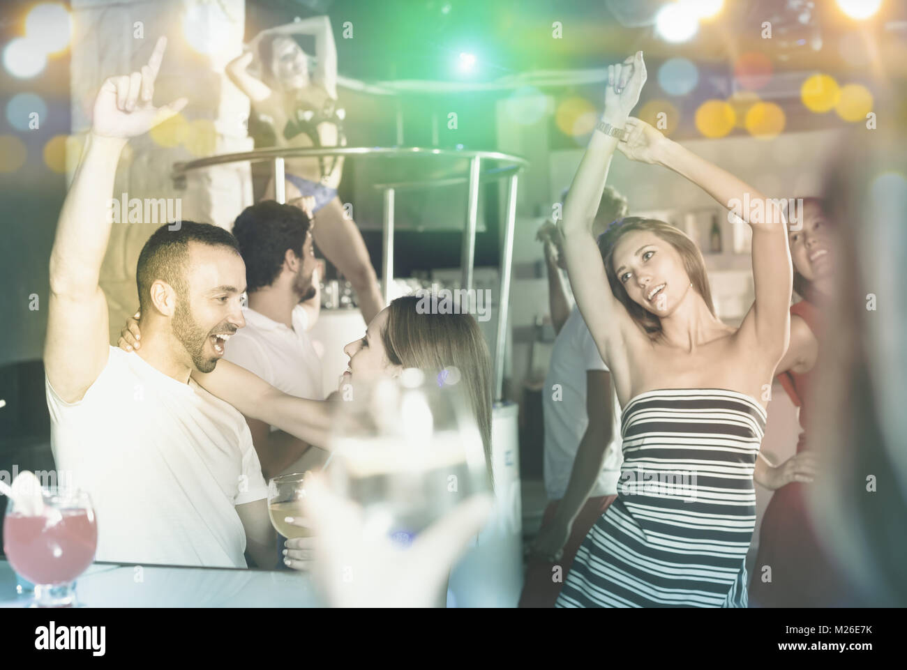 Female and male with cocktails dancing in a night club on party Stock ...