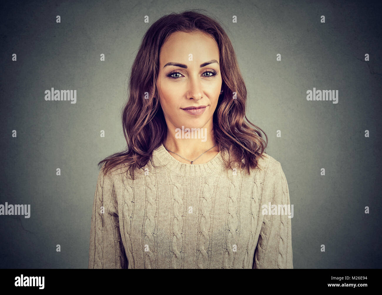 Young model looking skeptic posing at camera on gray background Stock ...