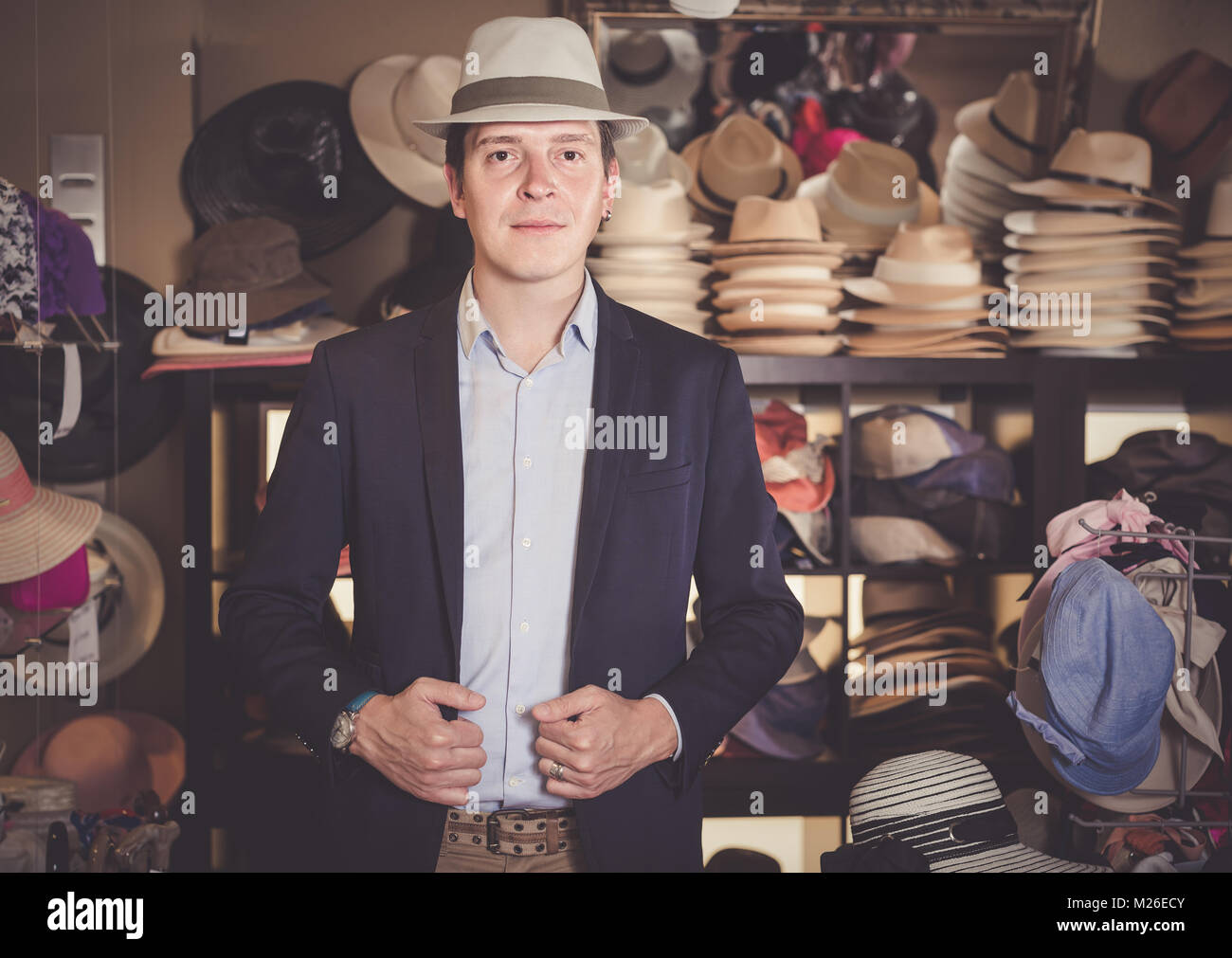portrait of male try on cap from the range at the shopping mall Stock ...