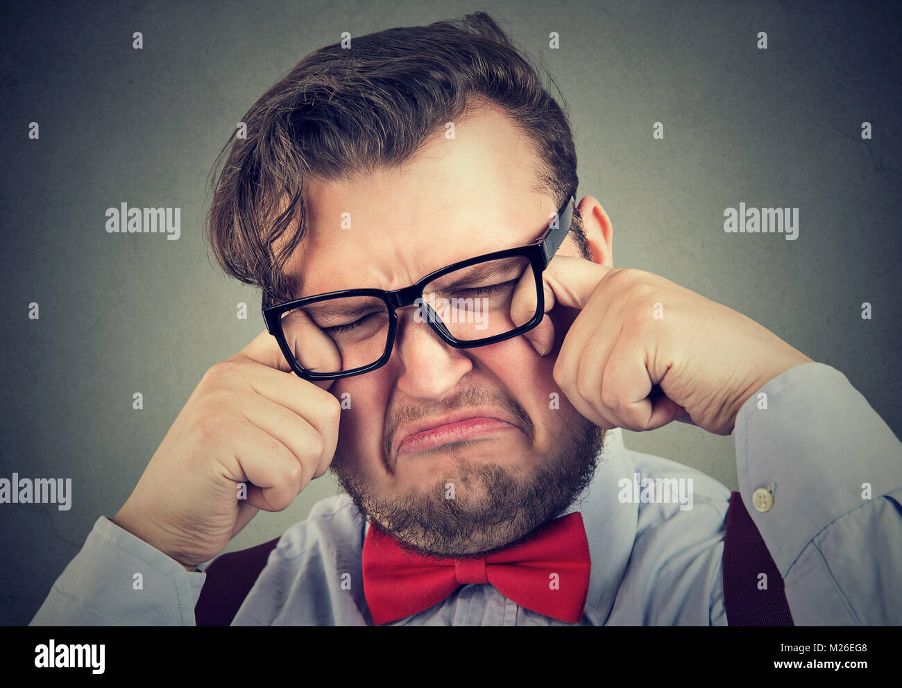 Chubby weak man crying like baby rubbing eyes Stock Photo - Alamy