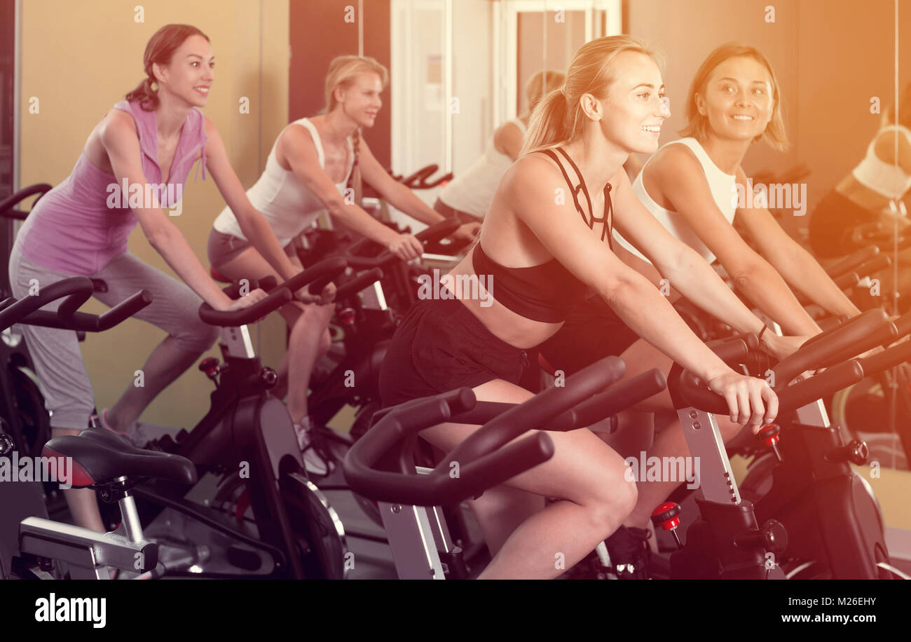 Sporty french women on cardio training on exercycles in health club ...