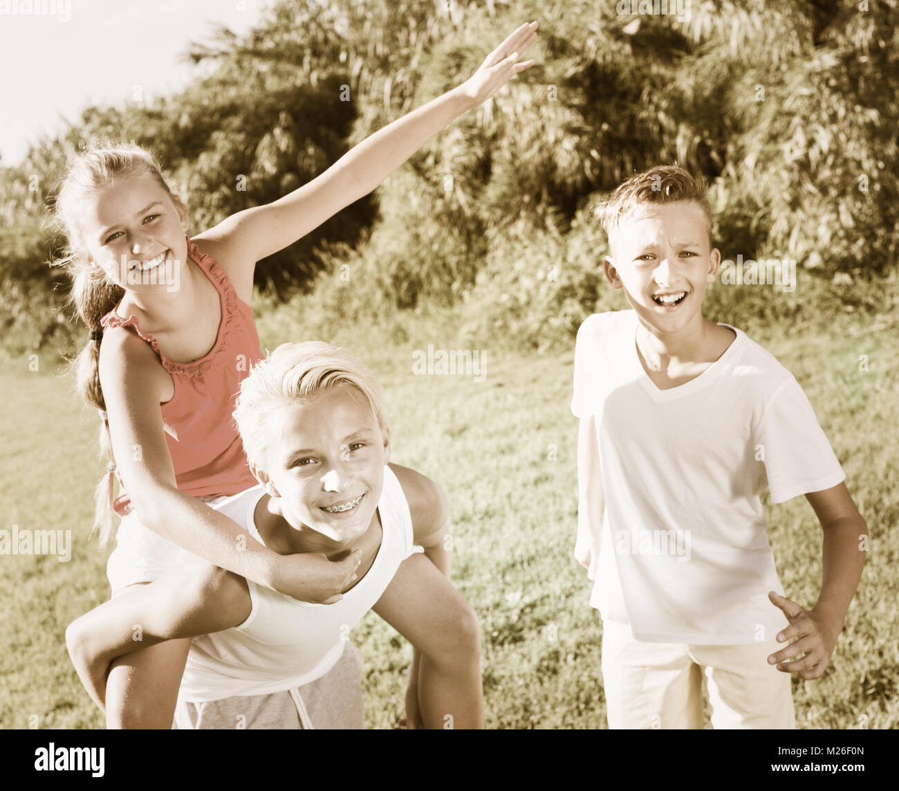 Group of laughing kids running happily together on grass Stock Photo ...