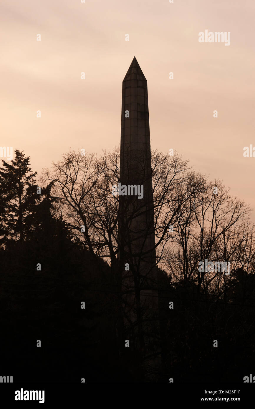 A silhouetted view of the Soviet-era 42-metre-high obelisk monument ...