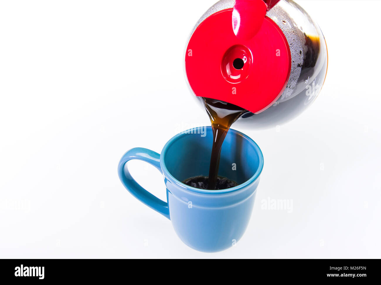 Pouring fresh Coffee red coffee maker into blue cup Stock Photo - Alamy