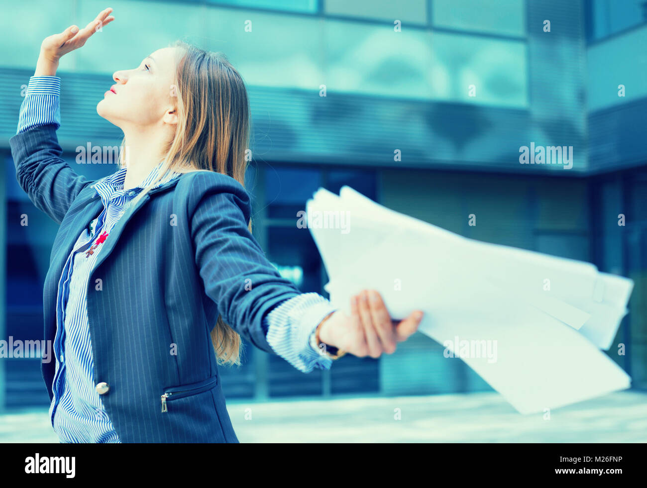 Professional woman in jacket working with documents at the street Stock ...