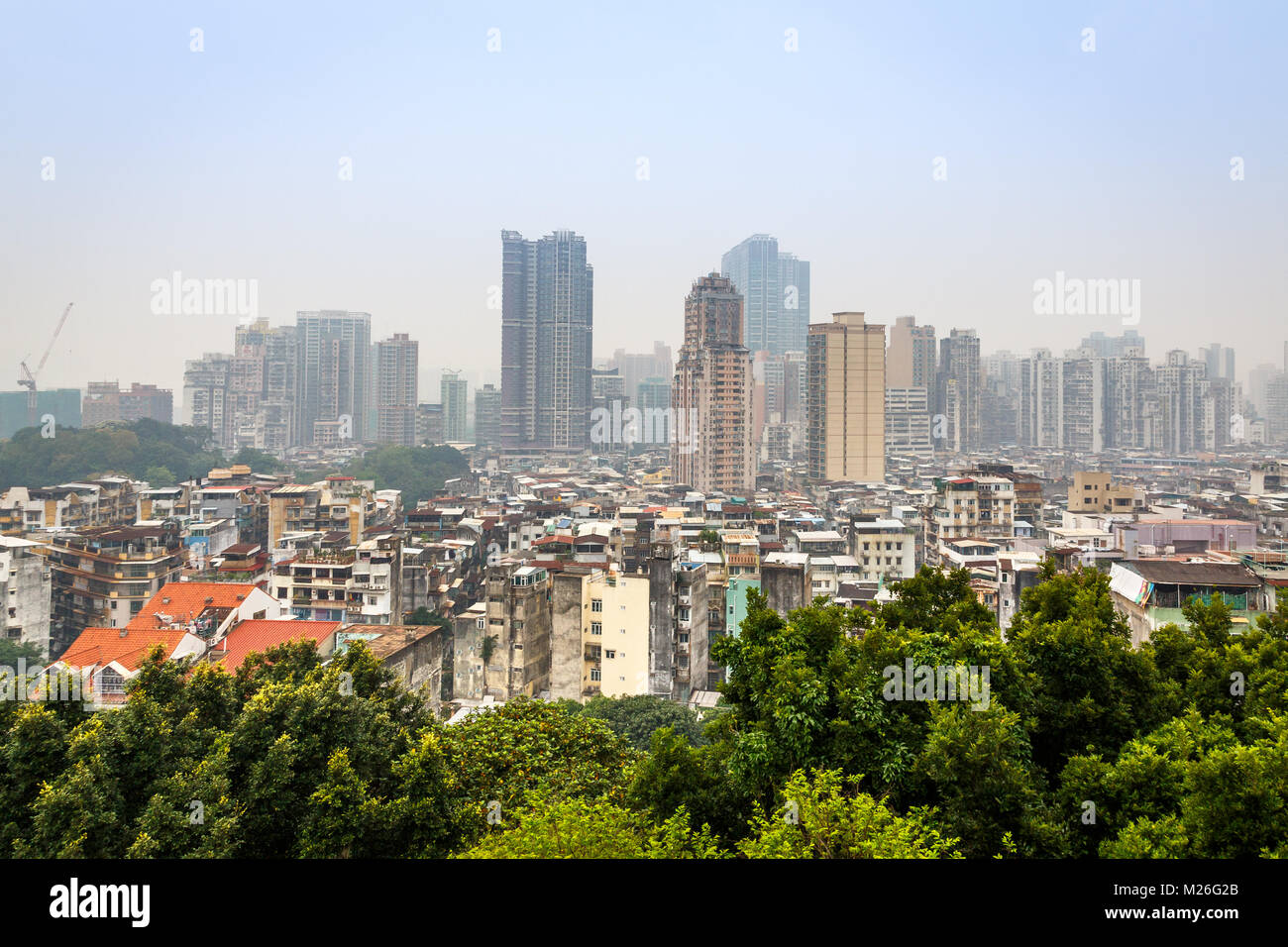 Macau city center panorama with slums and tall living buildings with ...