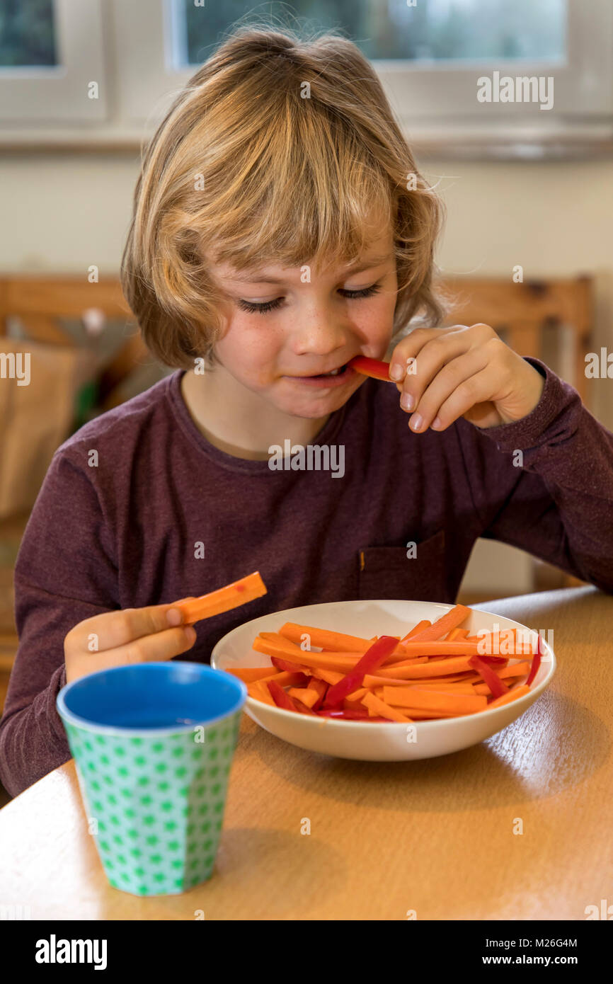 Boy eating carrot sticks hi-res stock photography and images - Alamy