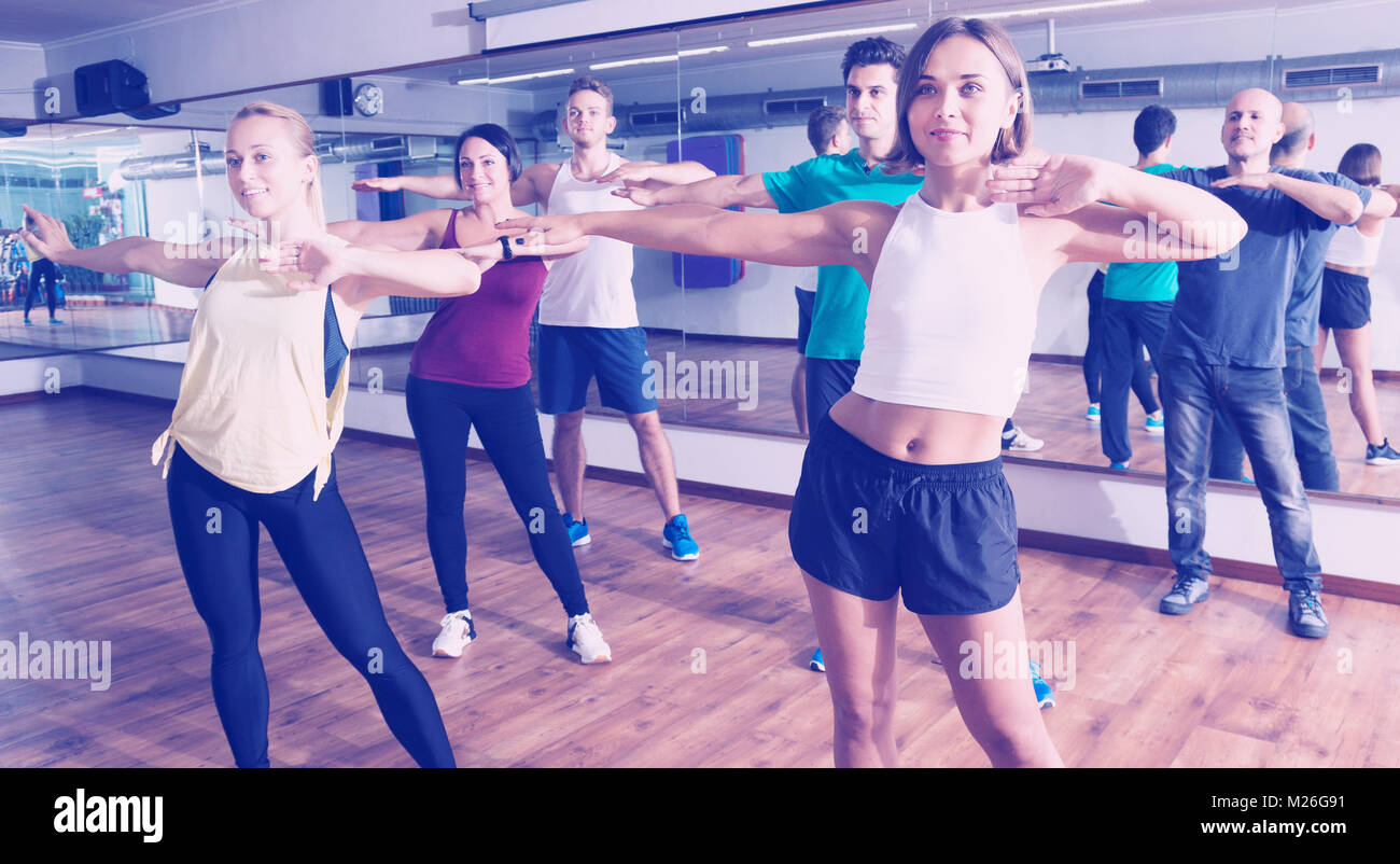Portrait of happy men and ladies dancing zumba at lesson Stock Photo ...