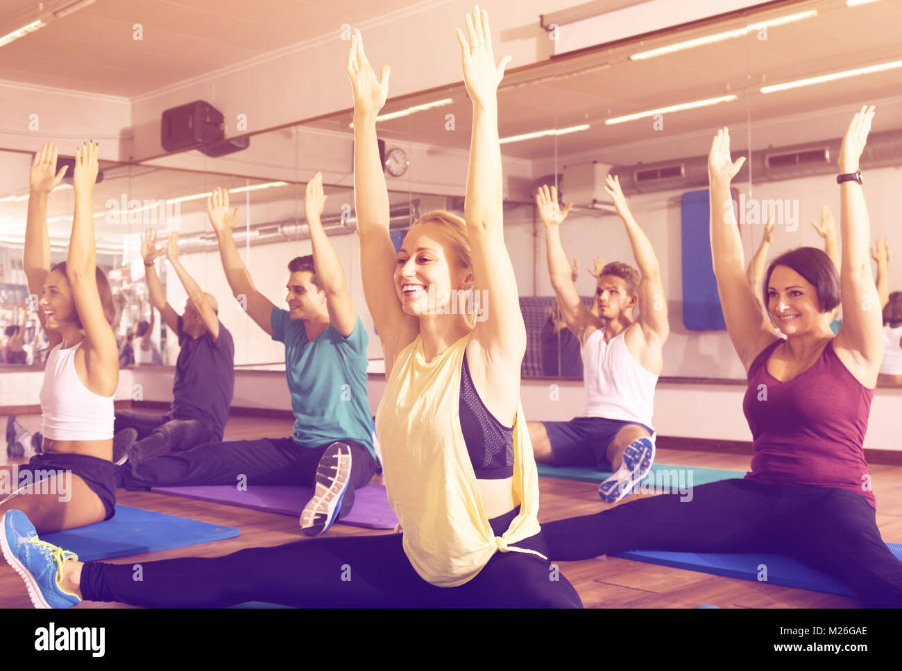Young positive people exercising in dance hall indoor Stock Photo - Alamy