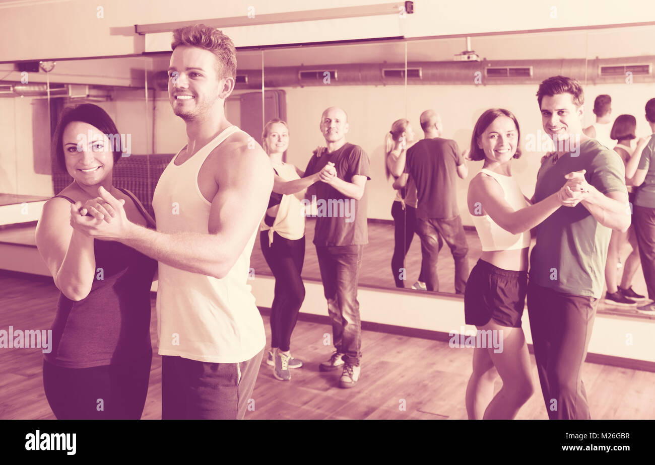 Smiling people dancing bachata together in dance class Stock Photo - Alamy