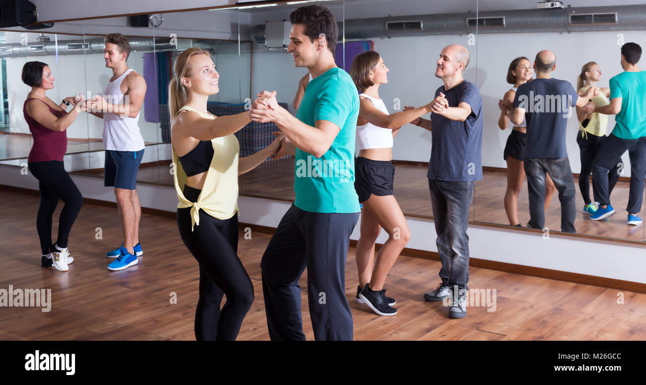 Friendly adults dancing bachata in dance studio Stock Photo - Alamy