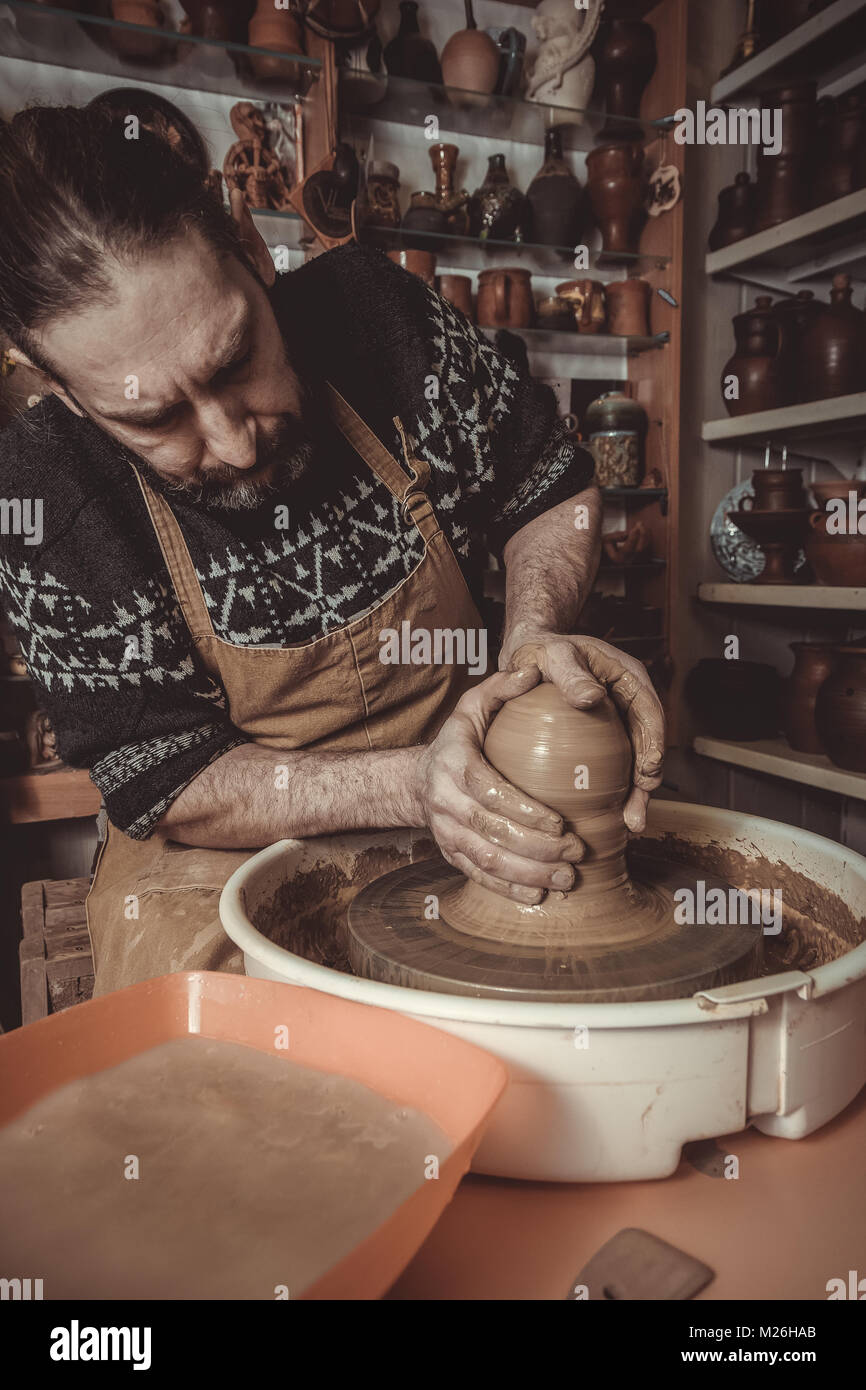 elderly man making pot using pottery wheel in studio Stock Photo - Alamy
