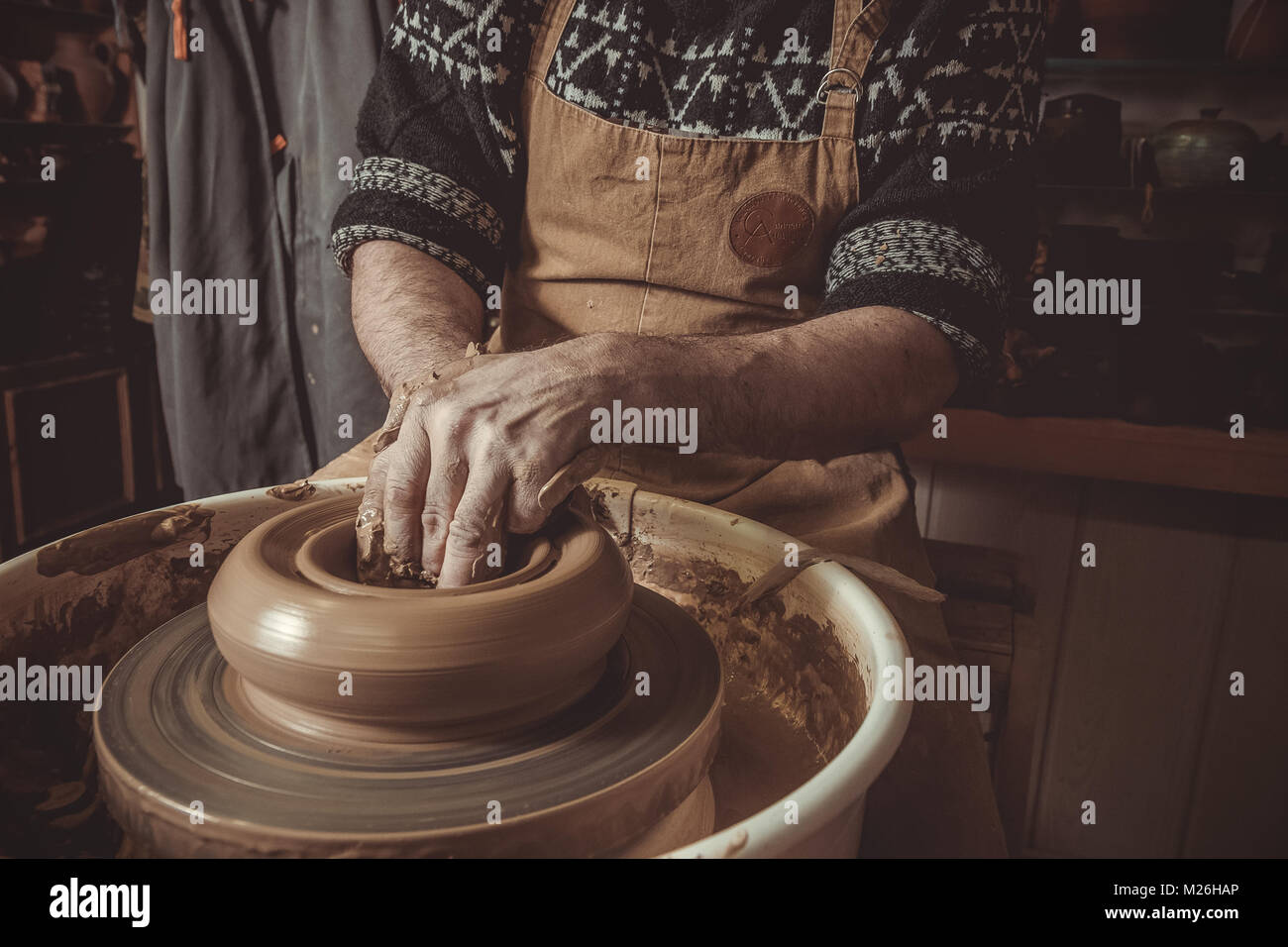 elderly man making pot using pottery wheel in studio Stock Photo - Alamy