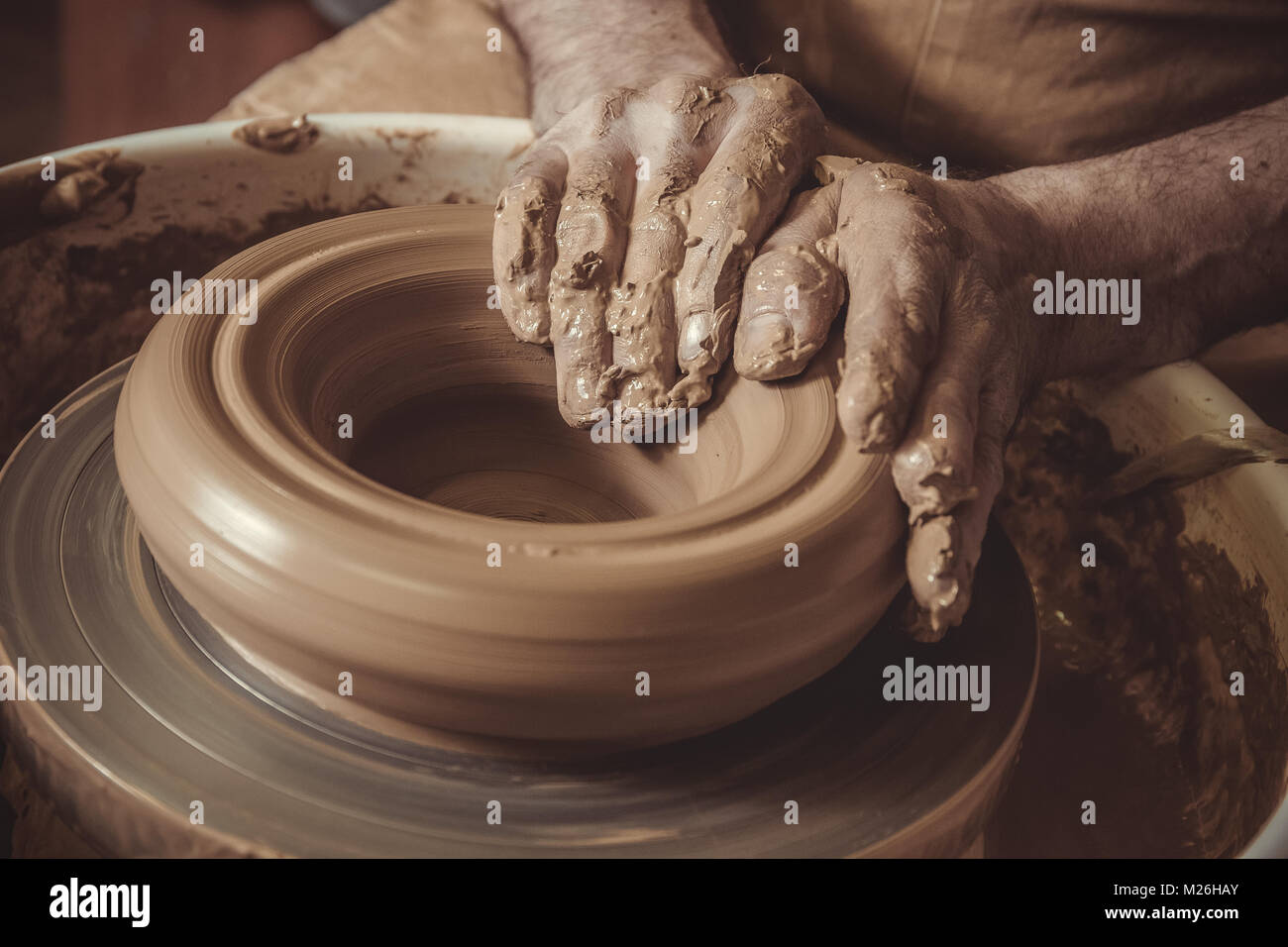 elderly man making pot using pottery wheel in studio Stock Photo - Alamy