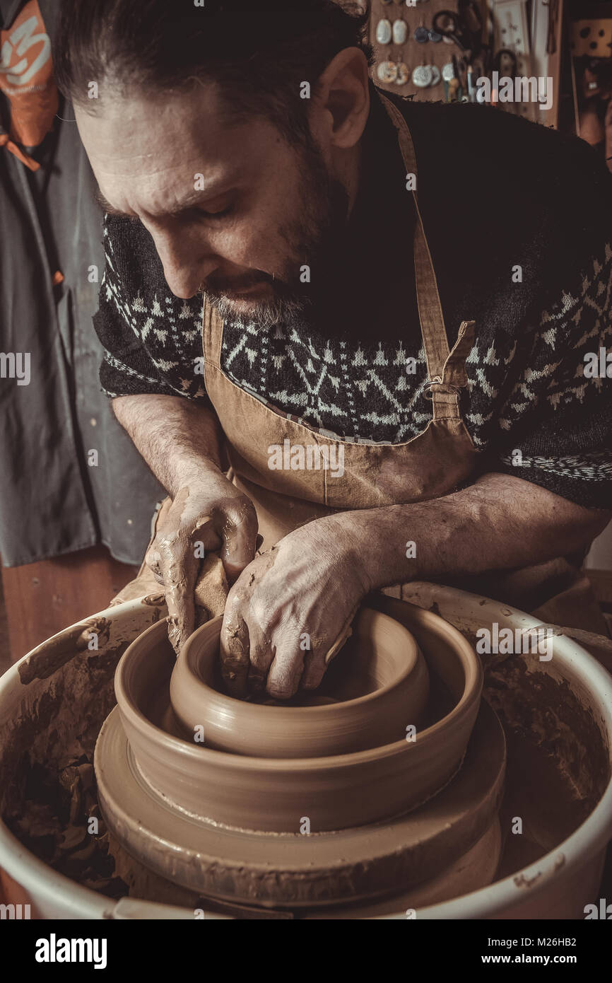 elderly man making pot using pottery wheel in studio Stock Photo - Alamy