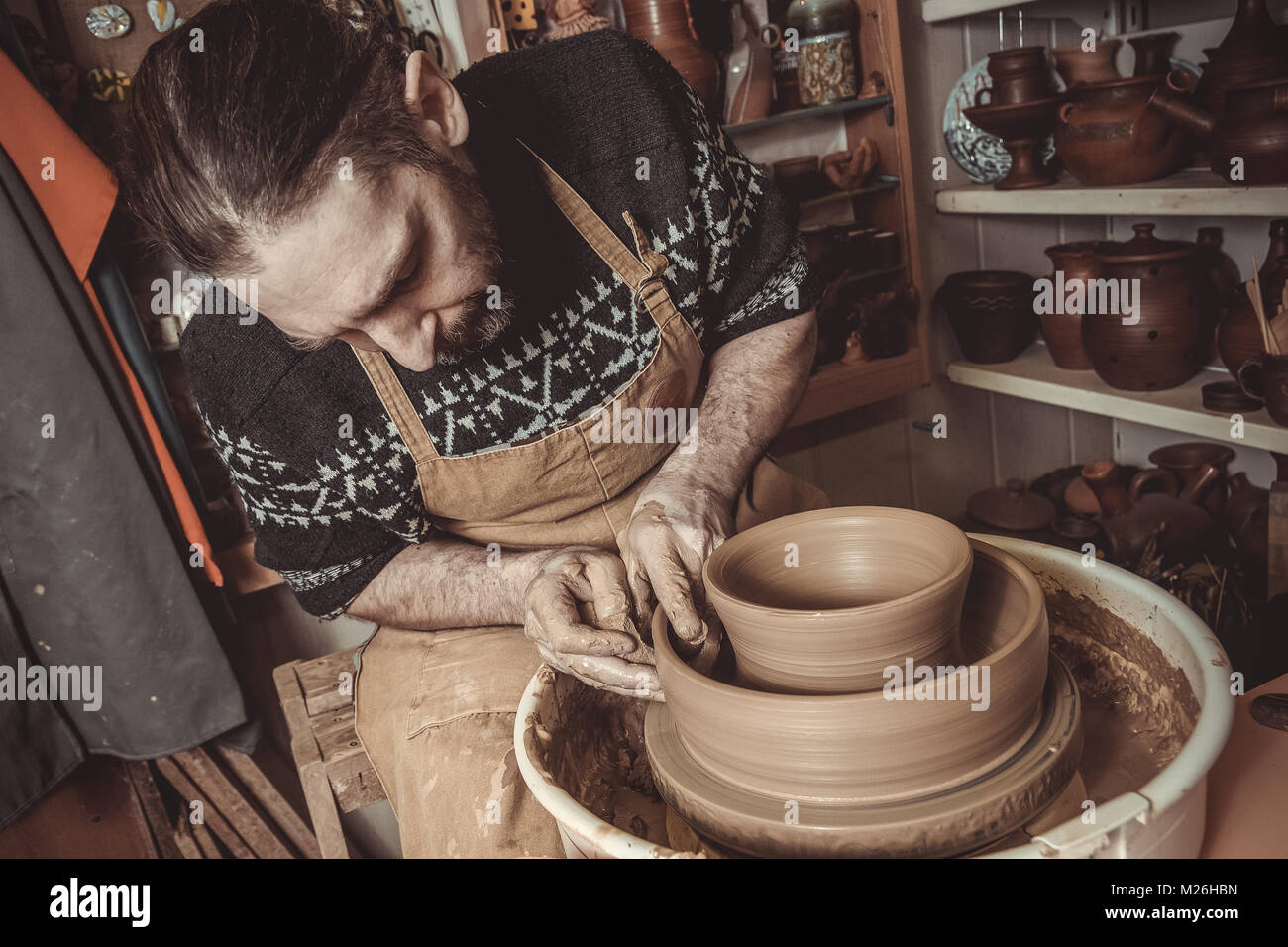 elderly man making pot using pottery wheel in studio Stock Photo - Alamy
