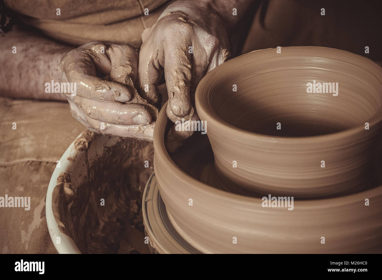 elderly man making pot using pottery wheel in studio Stock Photo - Alamy