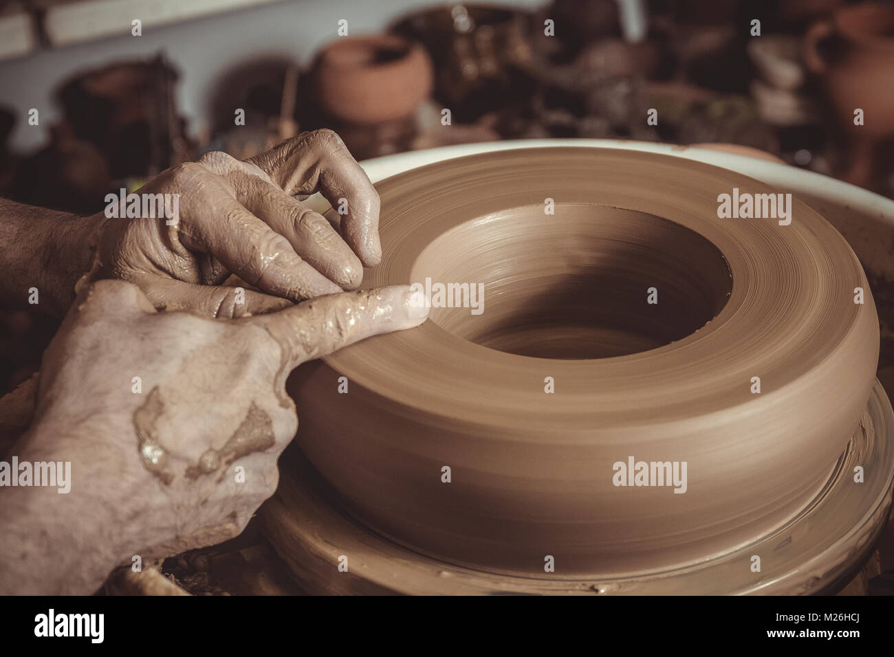 elderly man making pot using pottery wheel in studio Stock Photo - Alamy