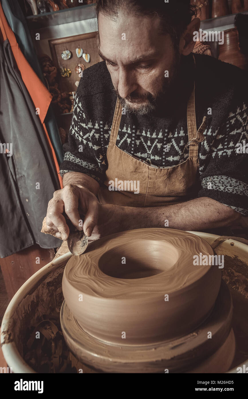 elderly man making pot using pottery wheel in studio Stock Photo - Alamy