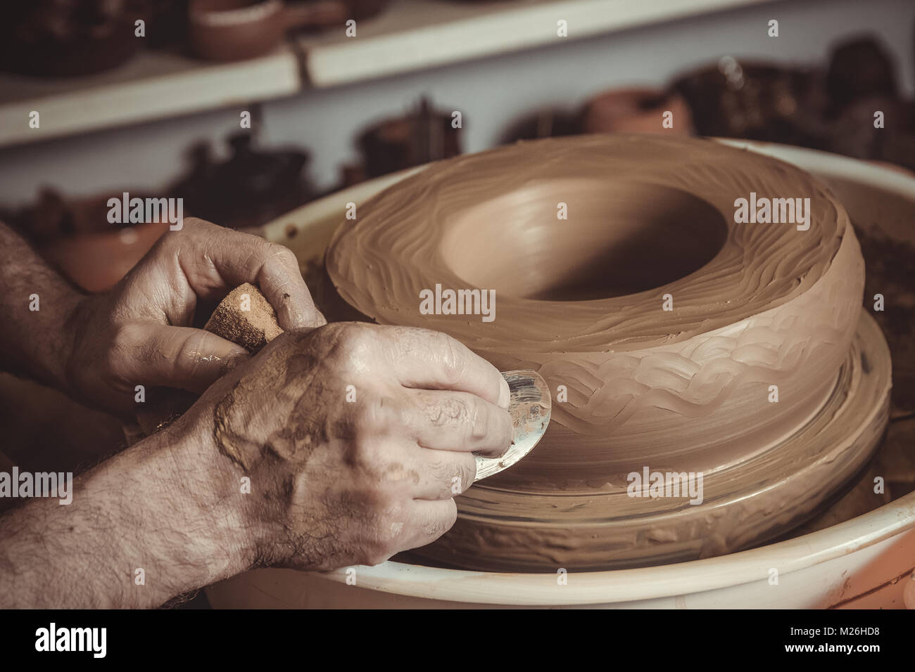 elderly man making pot using pottery wheel in studio Stock Photo - Alamy
