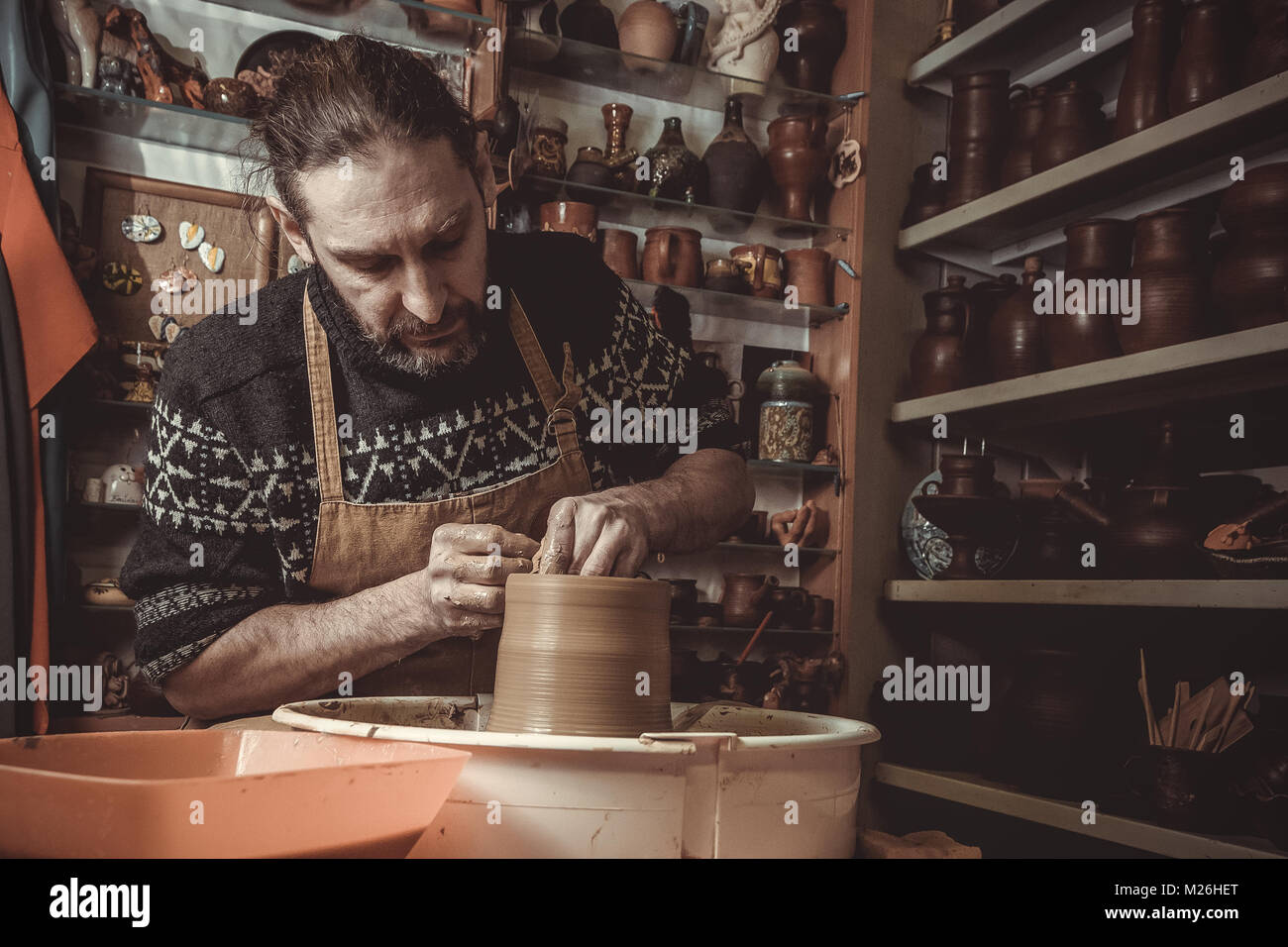 elderly man making pot using pottery wheel in studio Stock Photo - Alamy