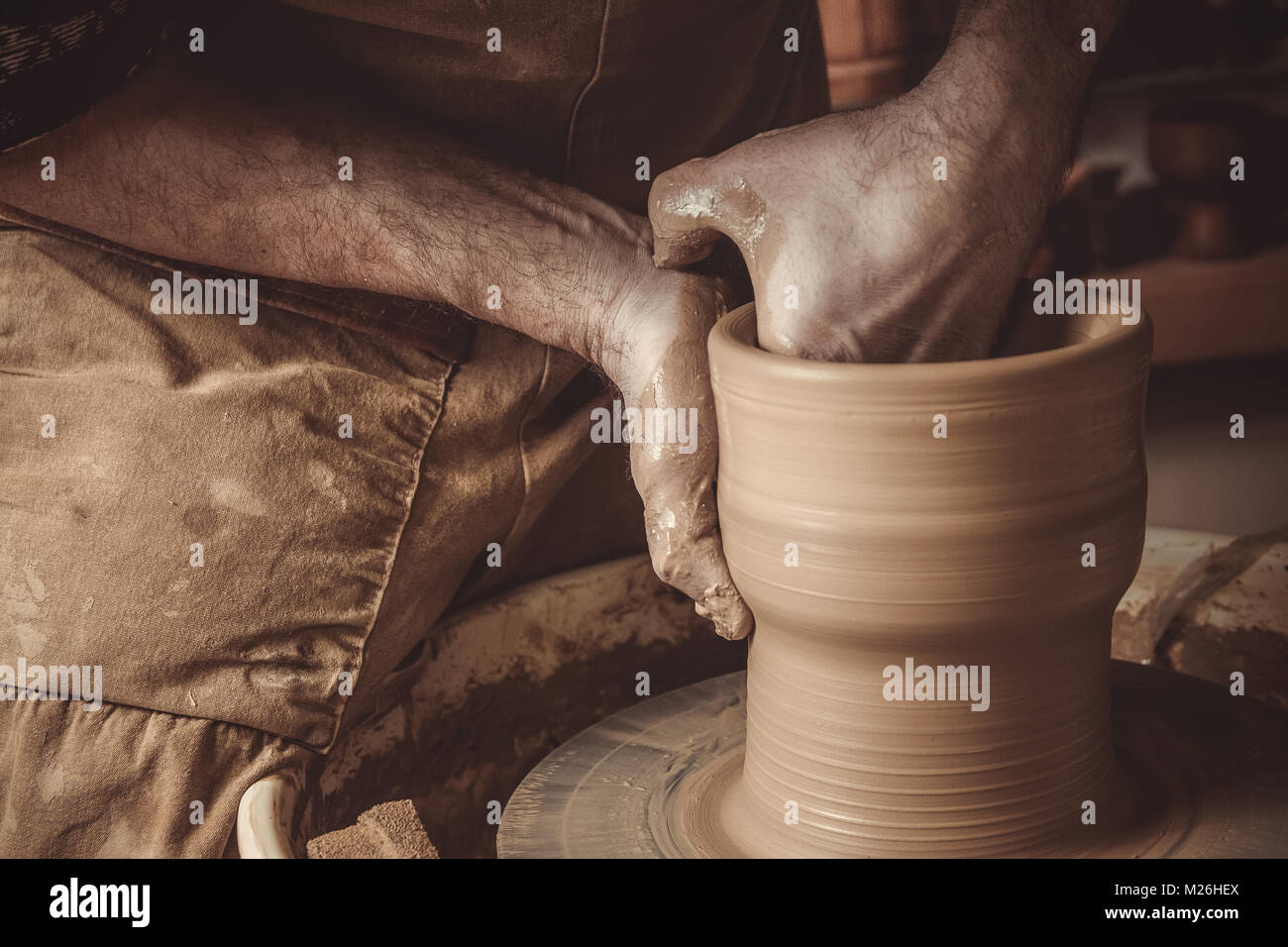 elderly man making pot using pottery wheel in studio Stock Photo - Alamy