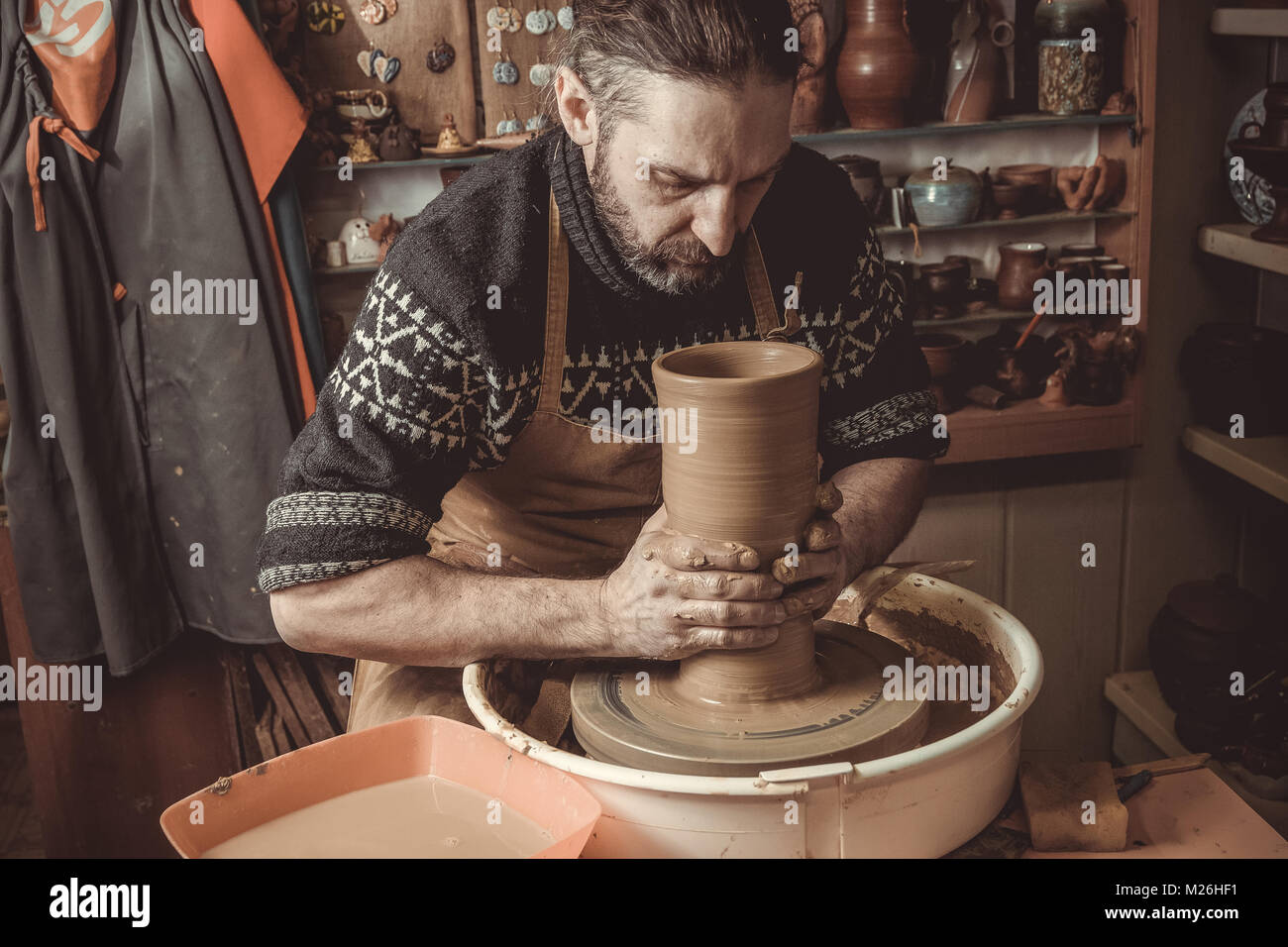 elderly man making pot using pottery wheel in studio Stock Photo - Alamy