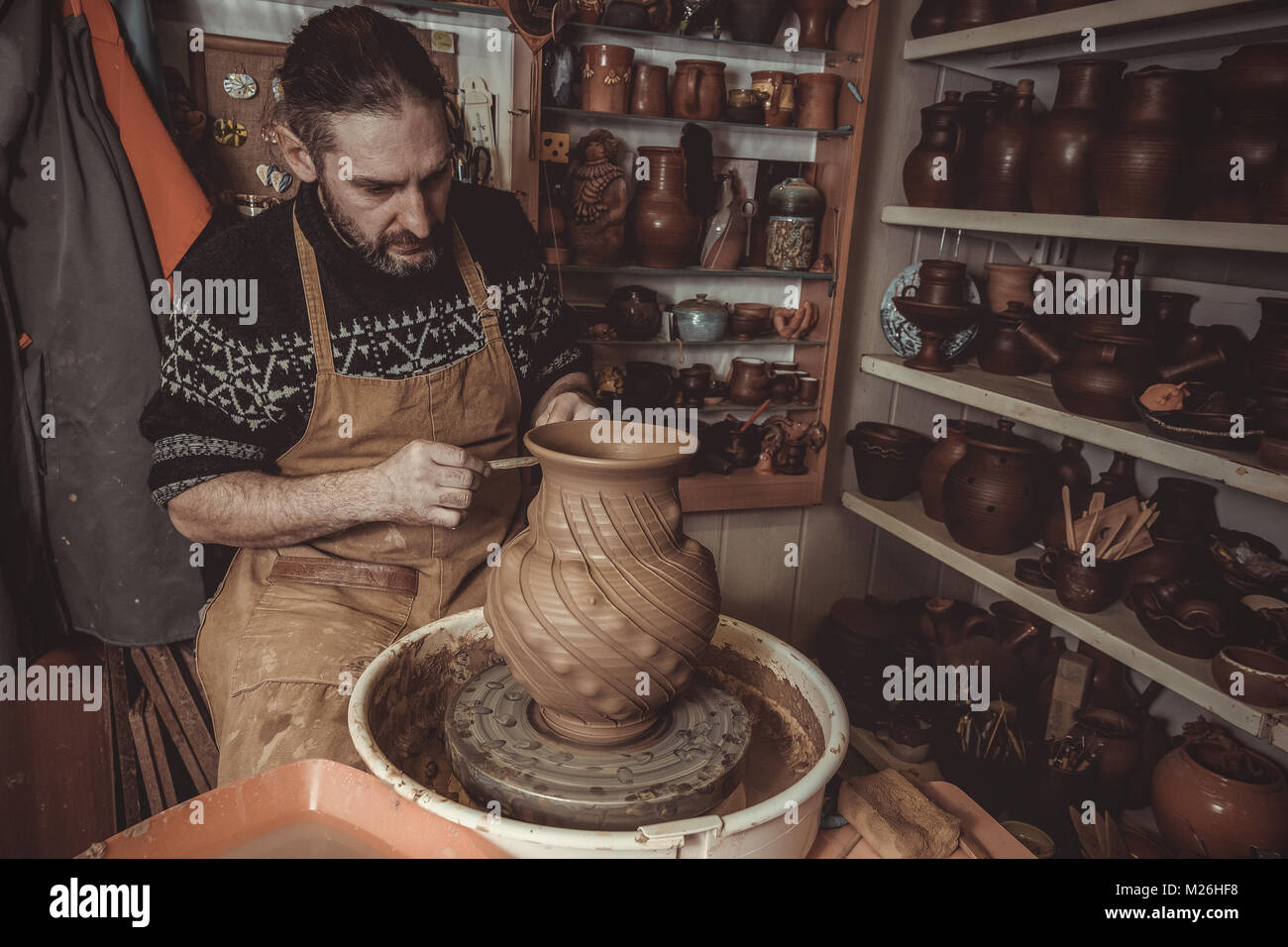 elderly man making pot using pottery wheel in studio Stock Photo - Alamy