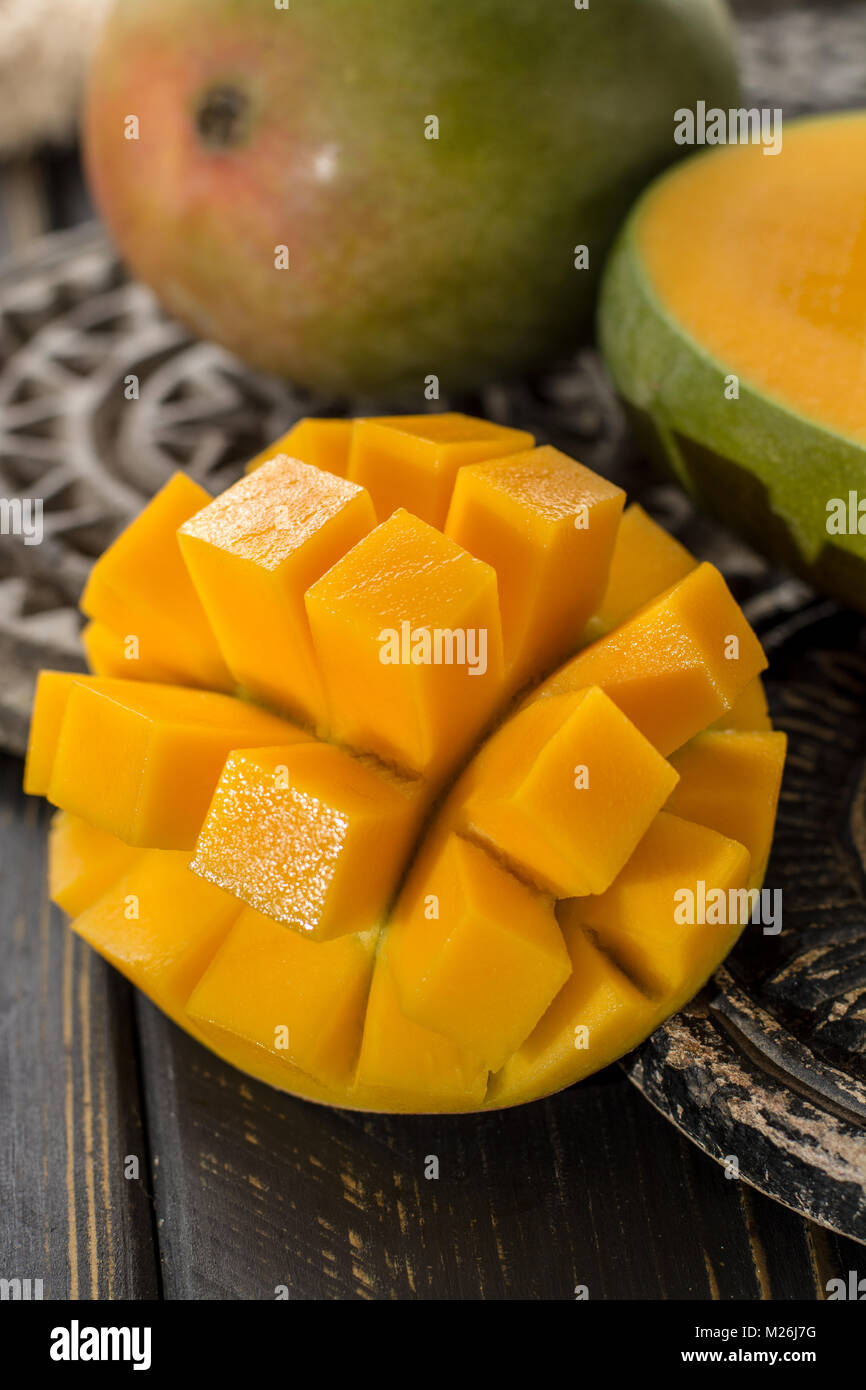 Tropical healthy fruit ripe organic mango close up in pieces ready to ...