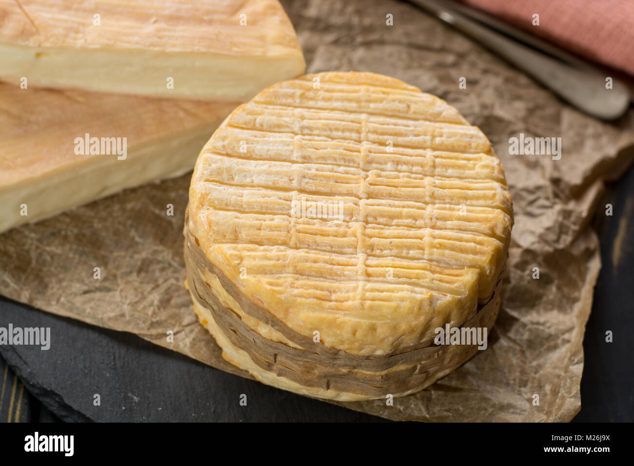 Tasting of oldest french AOC soft pudgent yellow cheese Livarot and ...