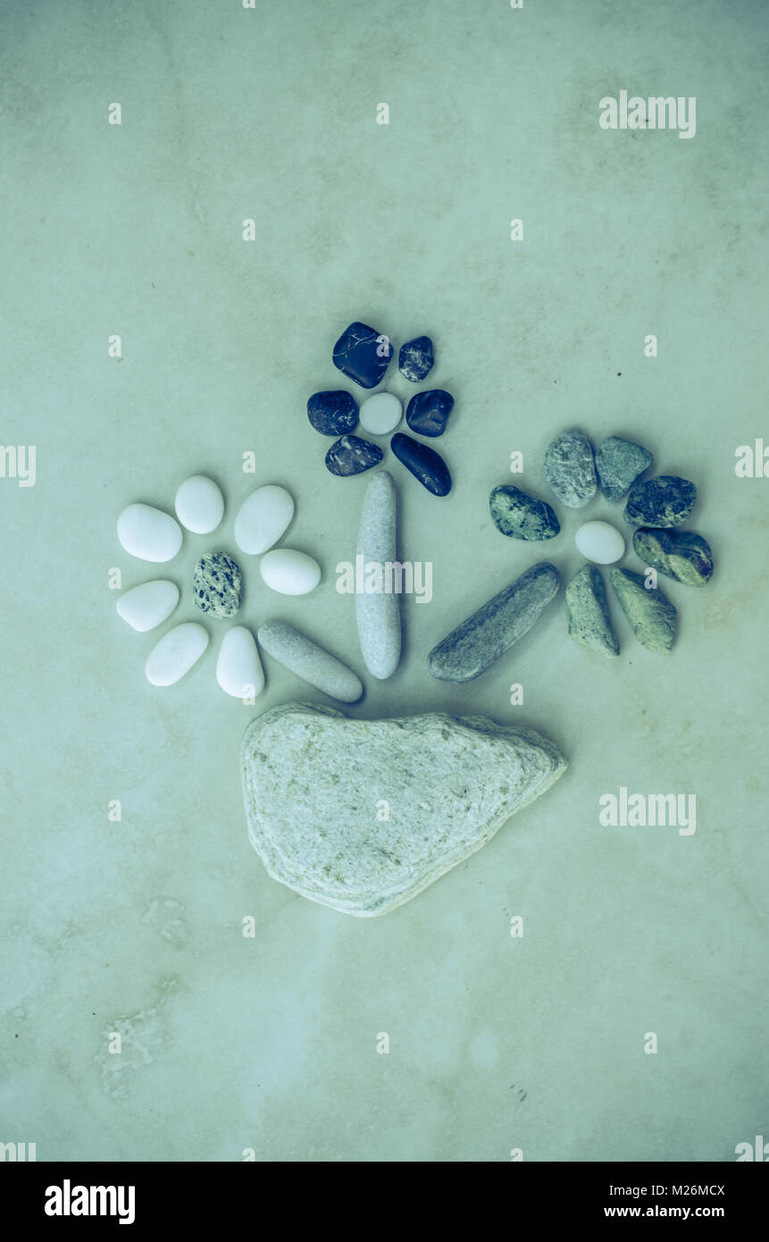 stony flowers in pot made from small pebbles Stock Photo - Alamy