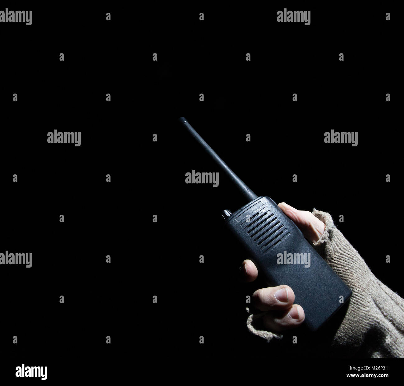 Handheld radio that runs on VHF frequencies in a gloved hand Stock ...